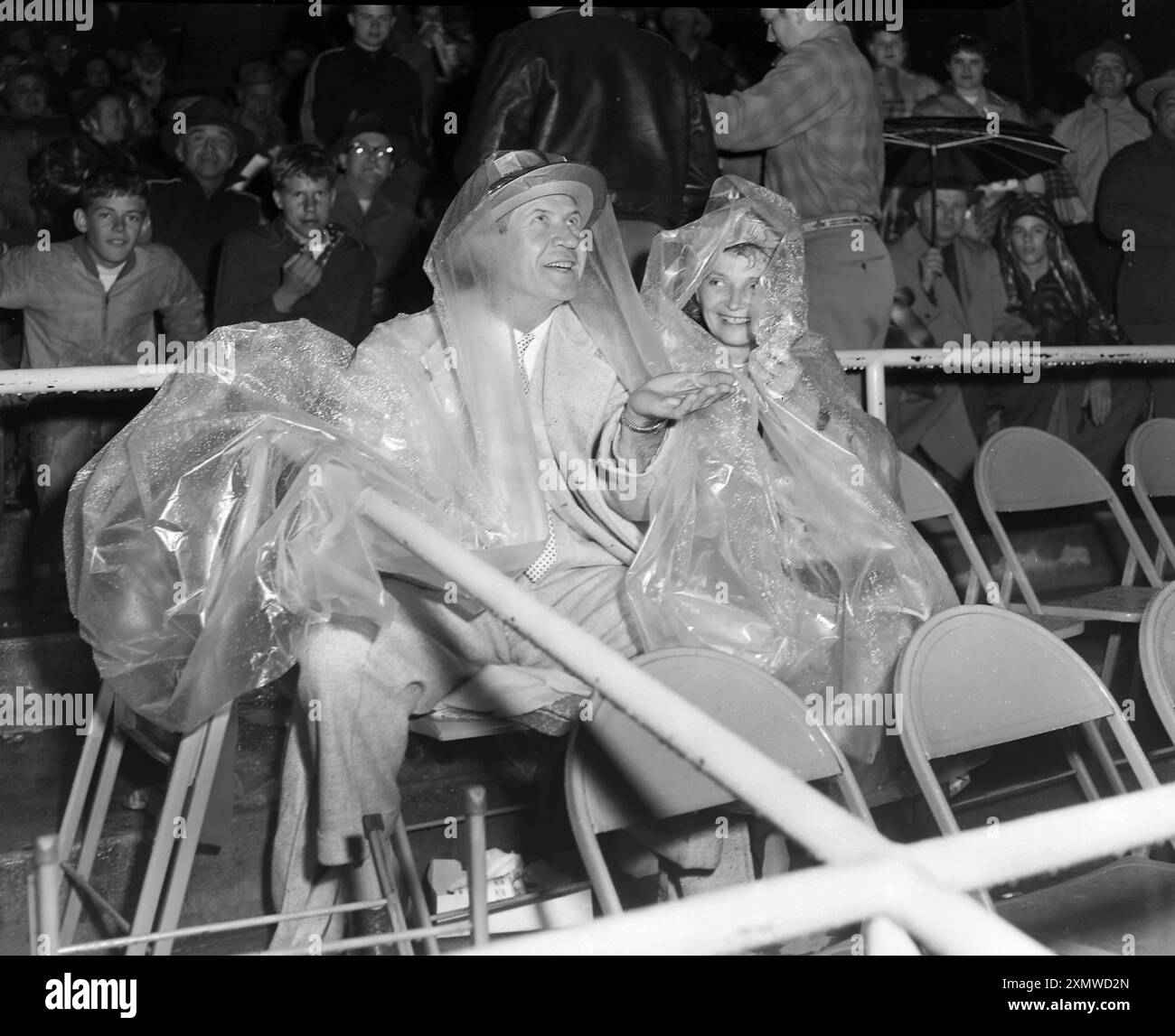 Fans wait out a rain delay at a Milwaukee Braves game at County Stadium ...