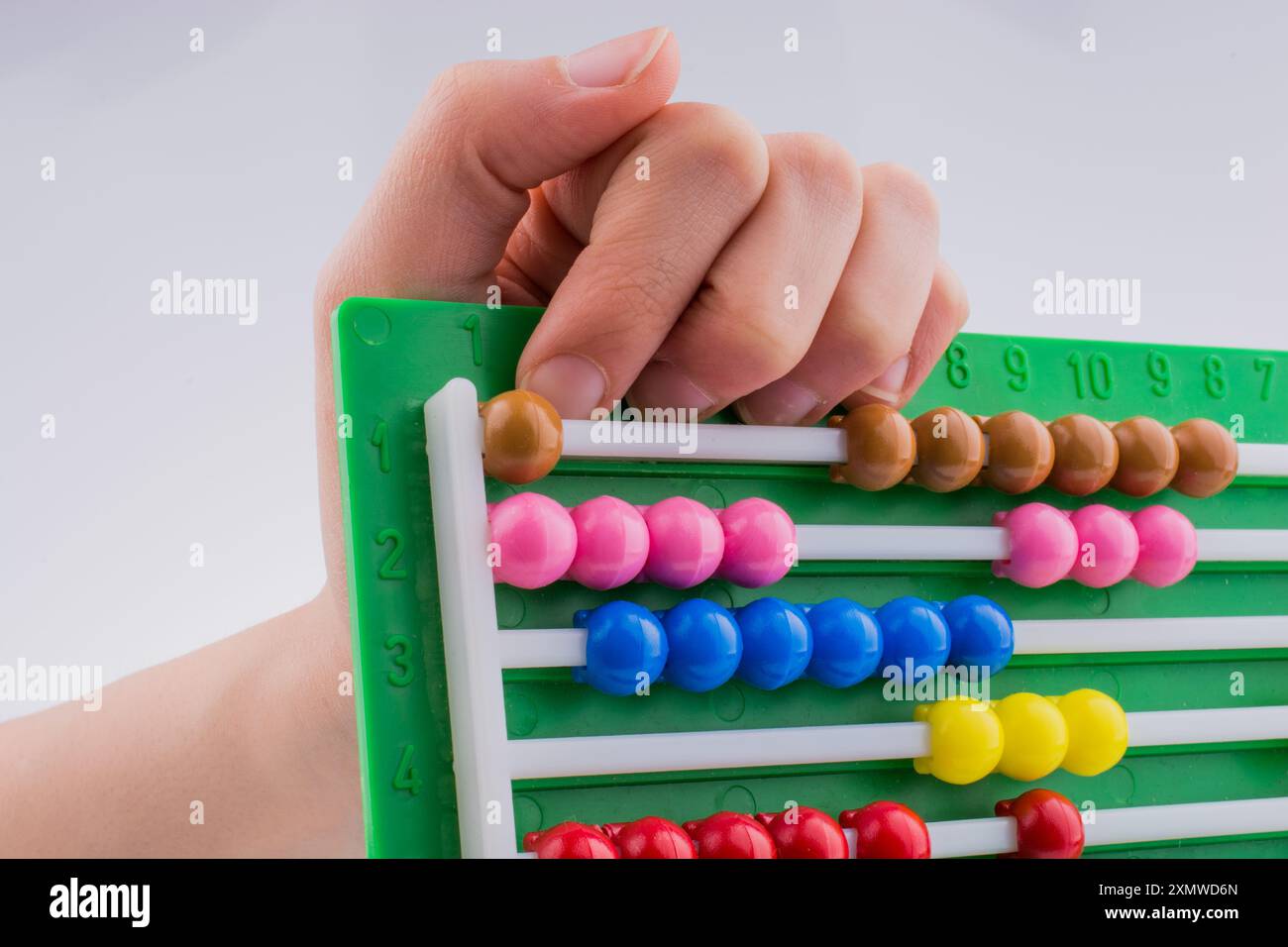 Hand using a color abacus Stock Photo - Alamy