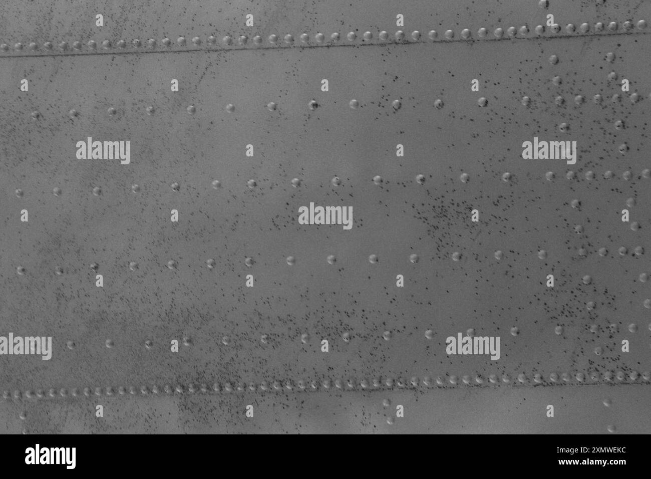 Abstract gray background of old, dirty metal airplane skin with rivets ...