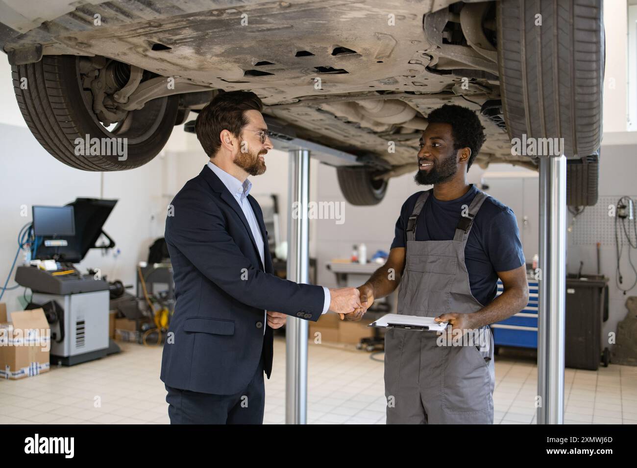 Mechanic businessman talking workshop hi-res stock photography and ...