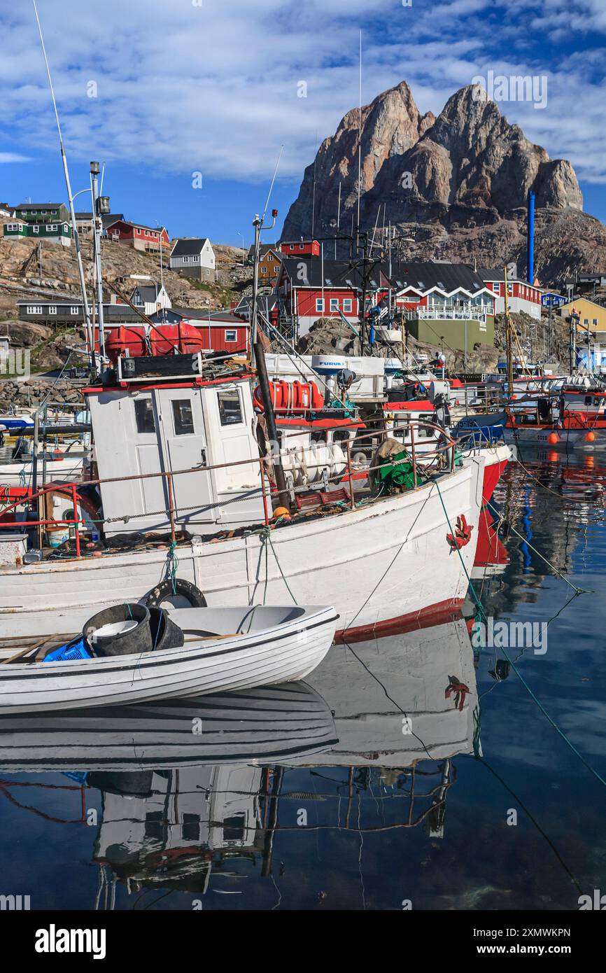 Harbor with boats in front of a village with mountains, sunny ...