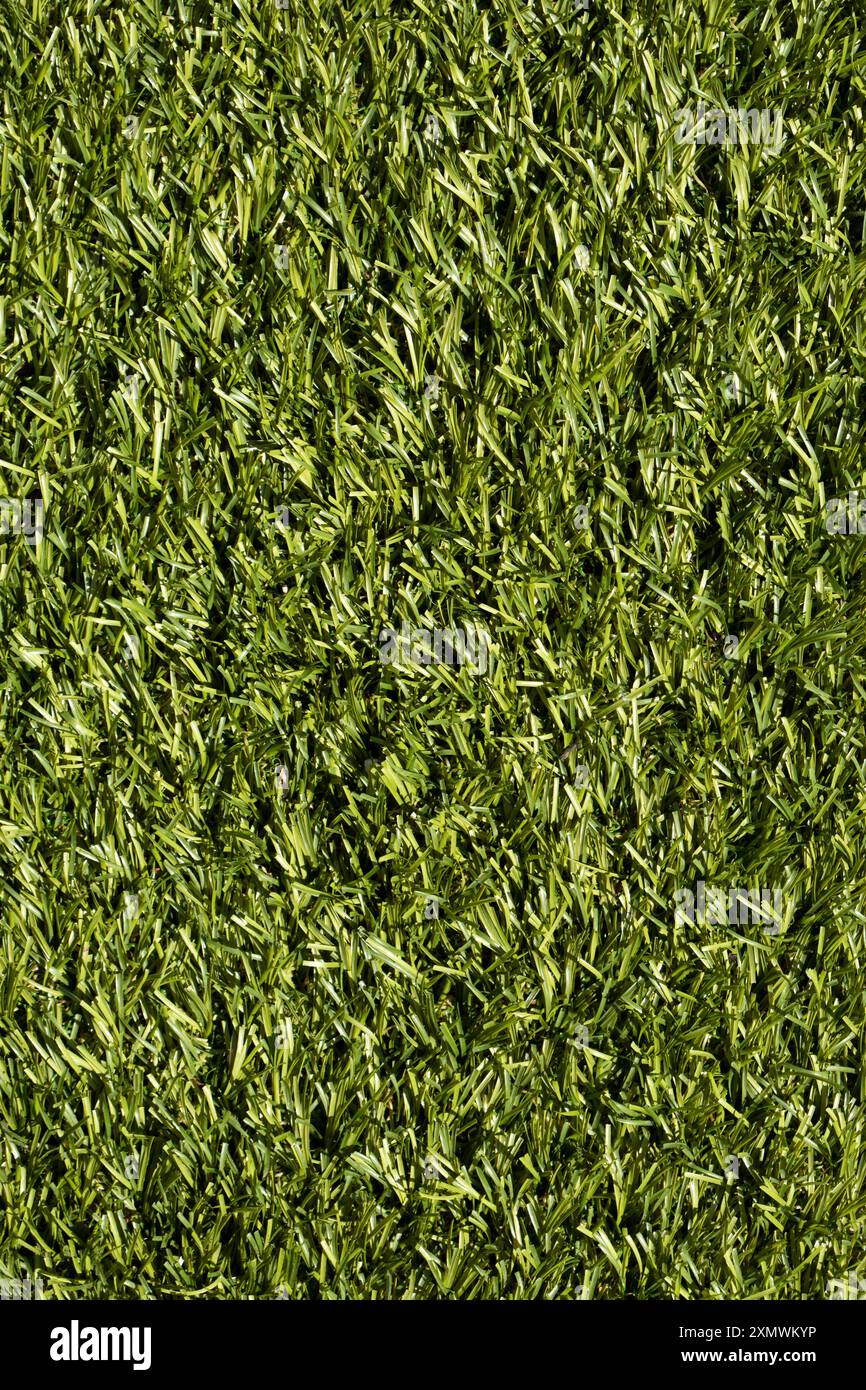 Artificial fake grass turf lawn background backdrop. Controversial use ...