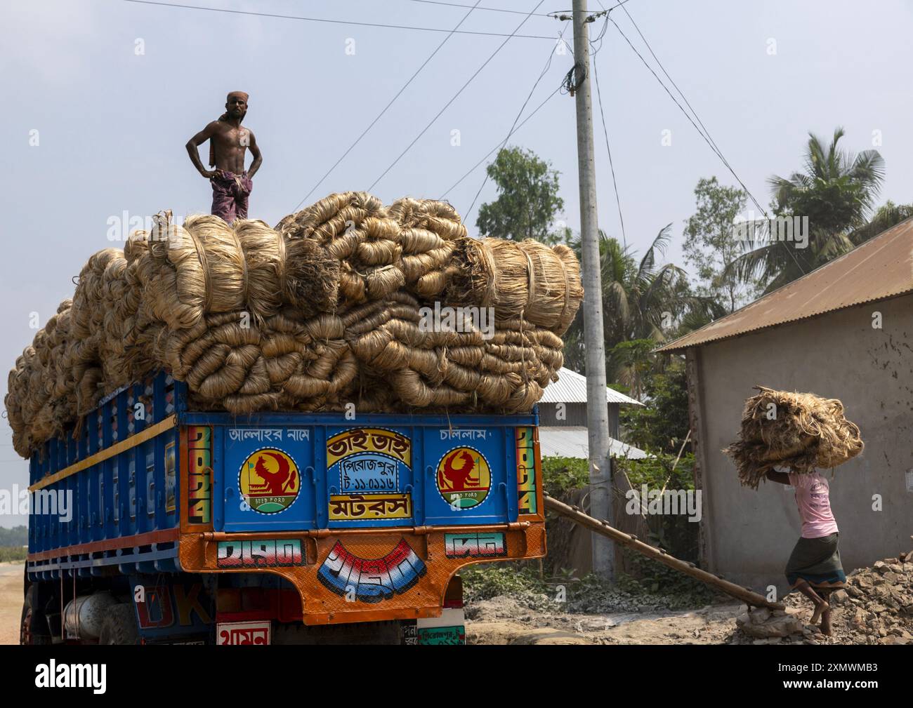 Bangladeshi man loading burlap on a truck, Dhaka Division, Nagarpur ...