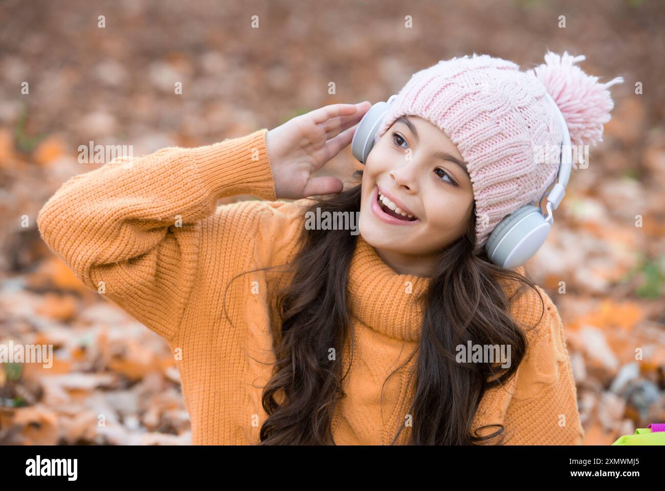 happy child listen music in headphones outdoor. autumn nature ...