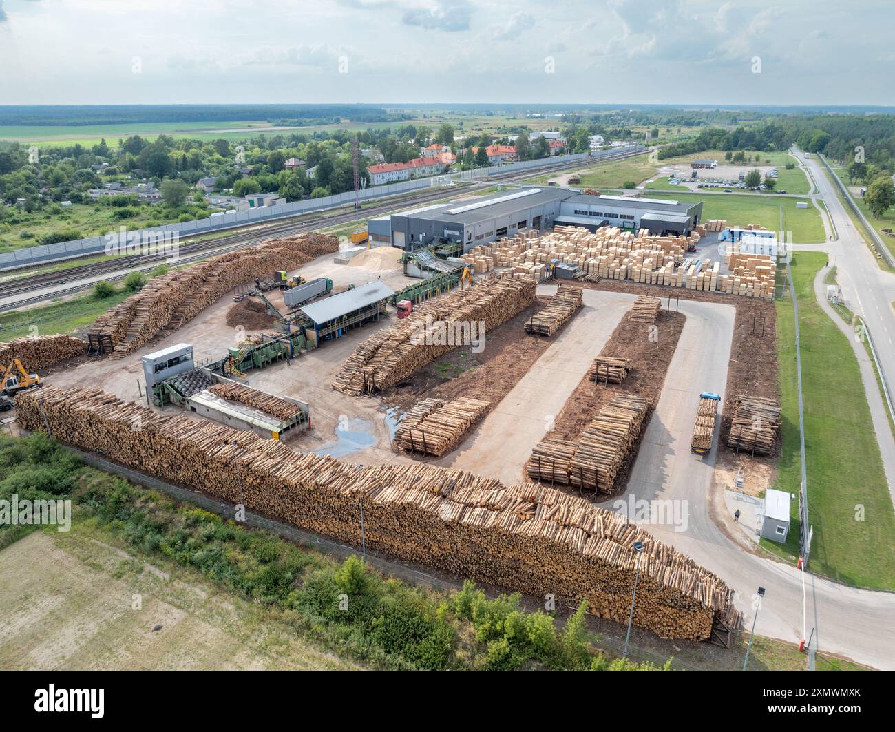 Wood sawmill, machinery for processing wood. Processing plant. A worker ...