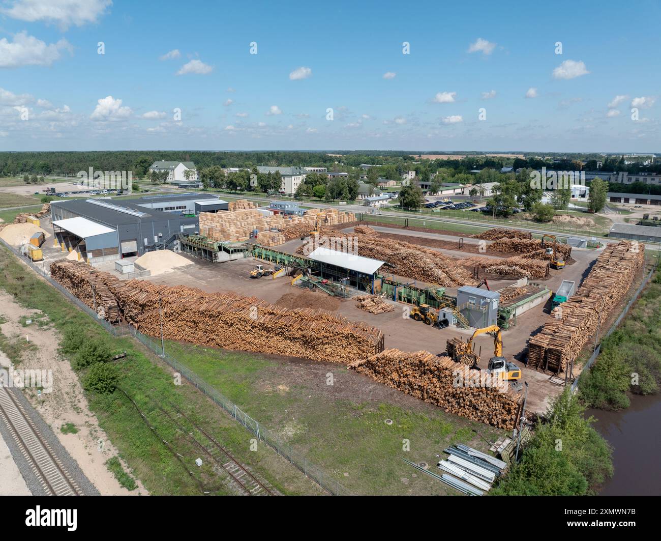 Wood sawmill, machinery for processing wood. Processing plant. A worker ...