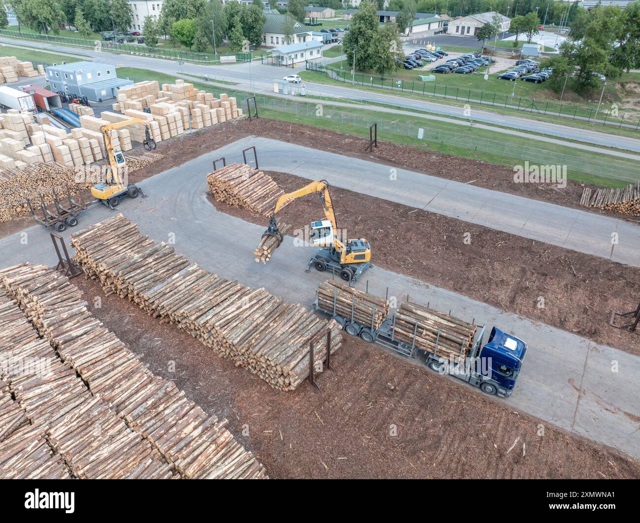 Wood sawmill, machinery for processing wood. Processing plant. A worker ...