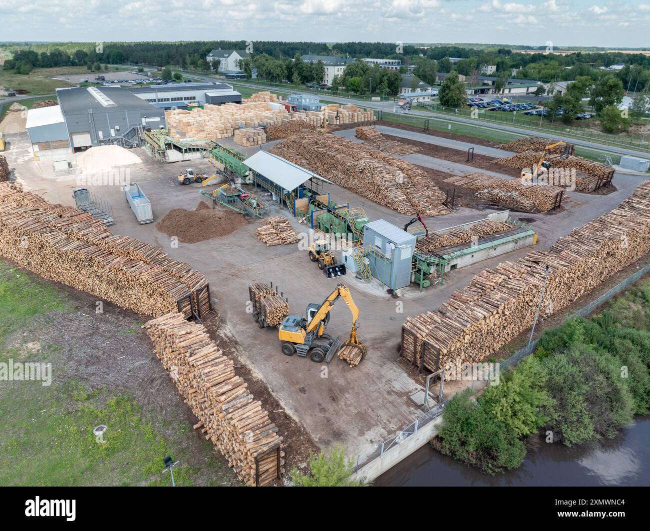 Wood sawmill, machinery for processing wood. Processing plant. A worker ...