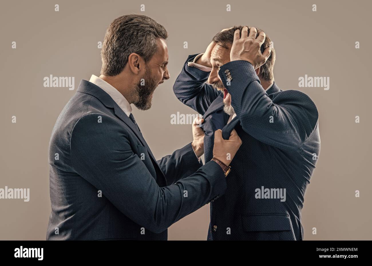 two arguing businessmen isolated on grey backdrop. businessmen arguing ...