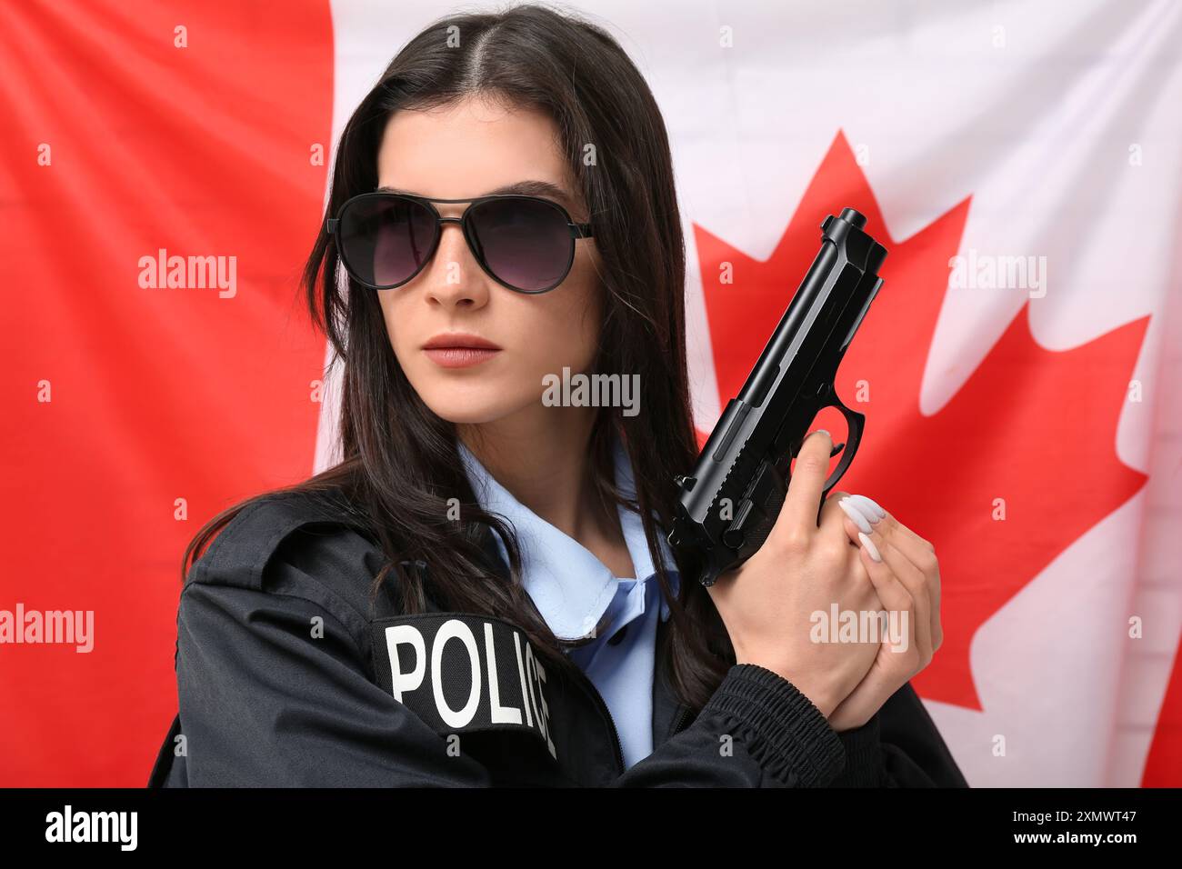 Female police officer with gun against flag of Canada Stock Photo - Alamy