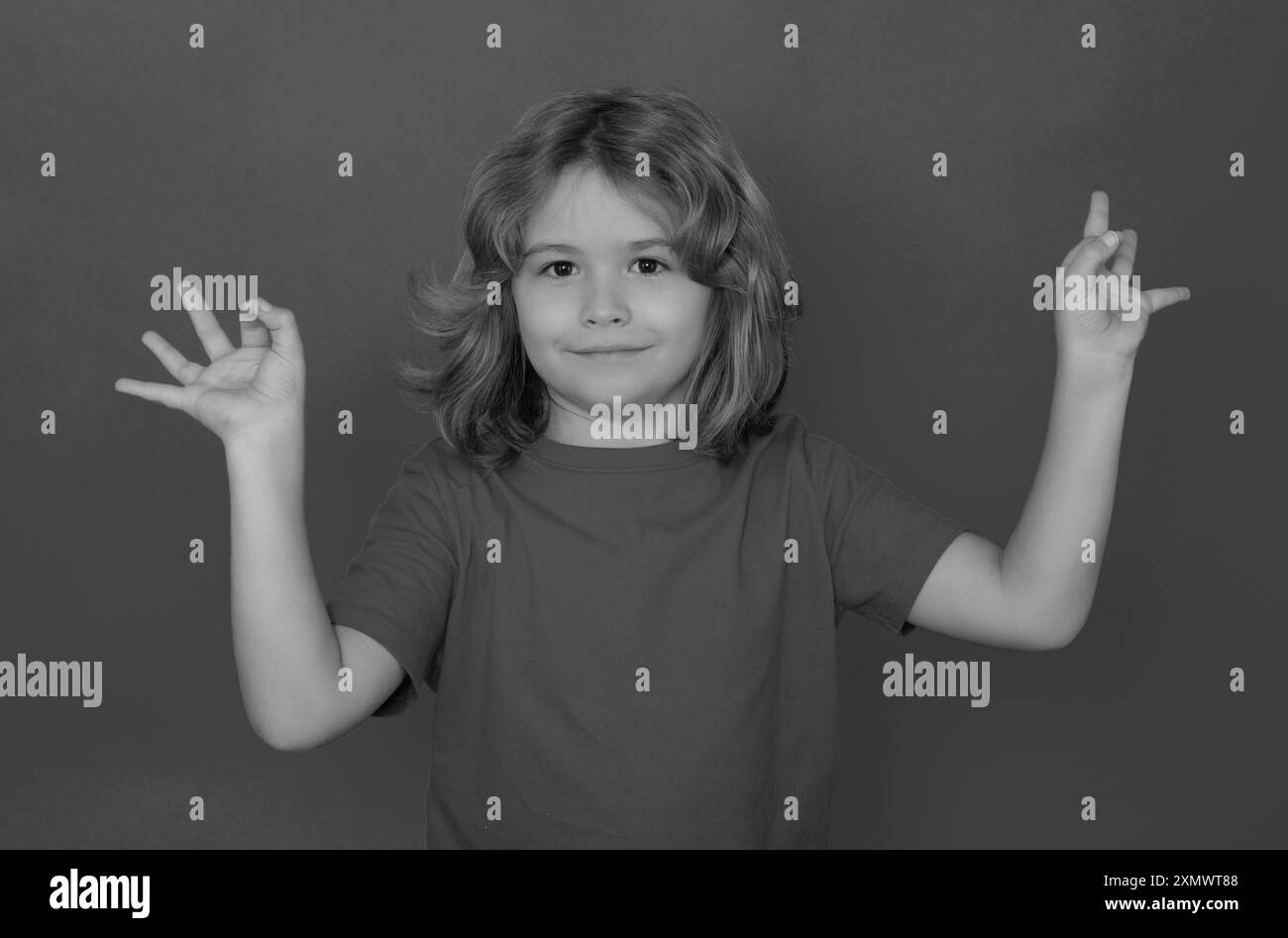 Child sign ok, okay gesture on isolated studio background. Happy kid ...