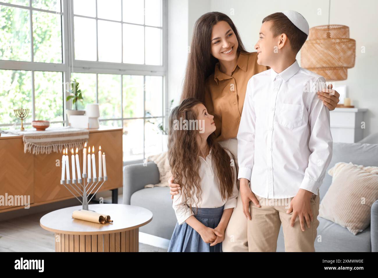 Happy Jewish mother hugging her little children at home Stock Photo - Alamy