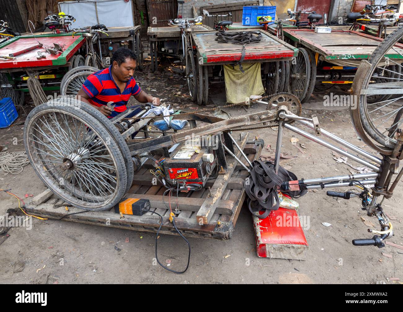 Bangladeshi mechanic repairing a rickshaw, Dhaka Division, Dhaka ...