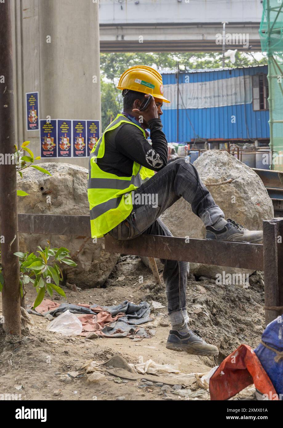 Bangladeshi construction worker calling on phone, Dhaka Division, Dhaka ...