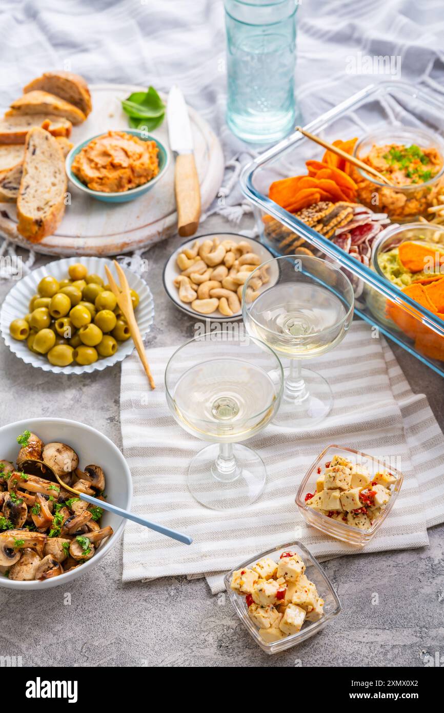 Two glasses of wine and tray with appertizers for a picnic, outdoor ...