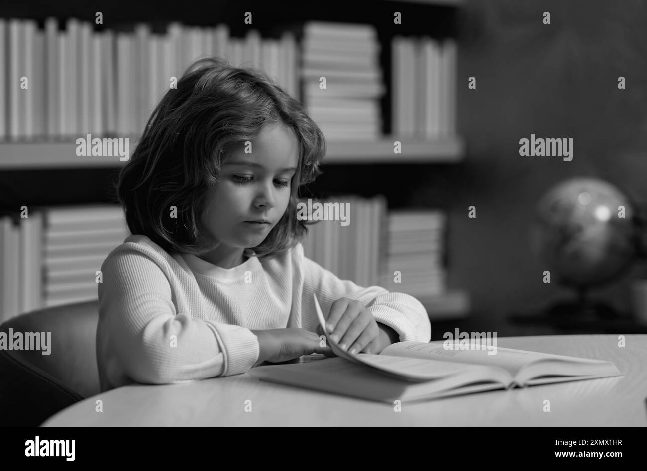 Elementary school boy. Little student on school library. Child reading ...