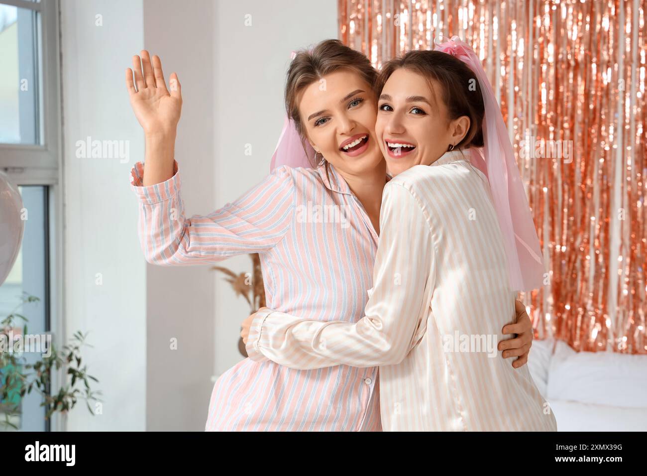 Happy bridesmaids hugging at Hen Party in bedroom Stock Photo - Alamy