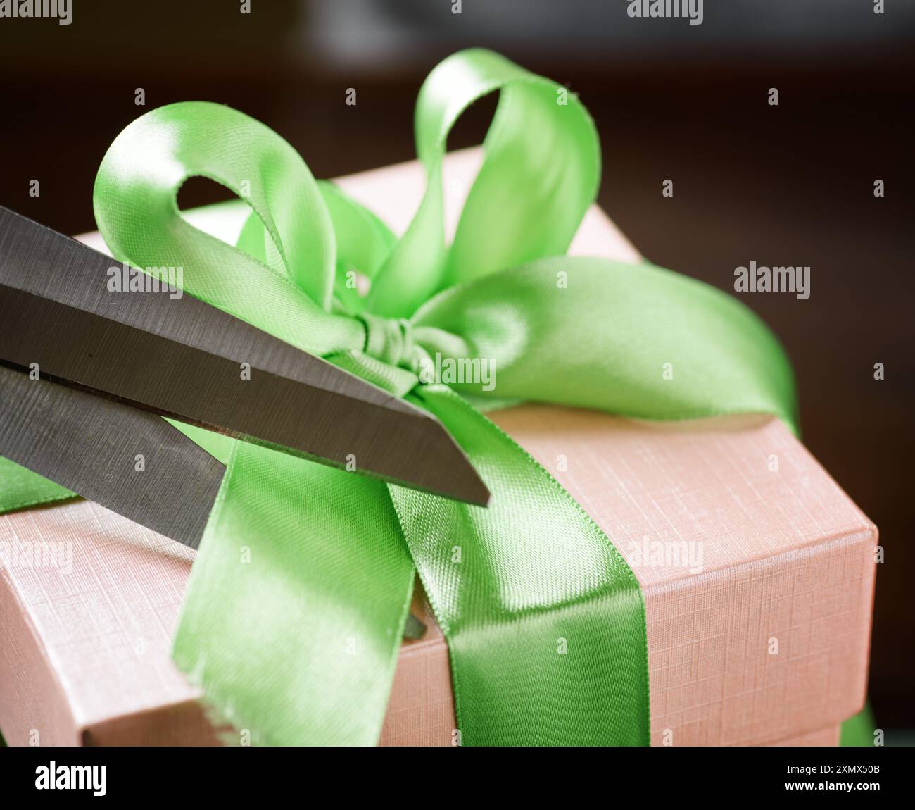 Decorating gift box with green ribbon using scissor Stock Photo - Alamy