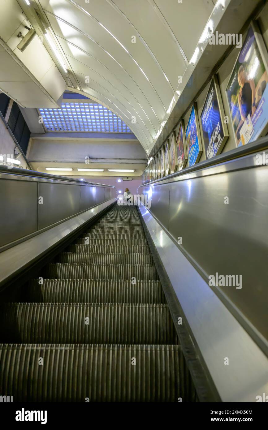 An empty escalator going down towards a London Tube station, empty ...