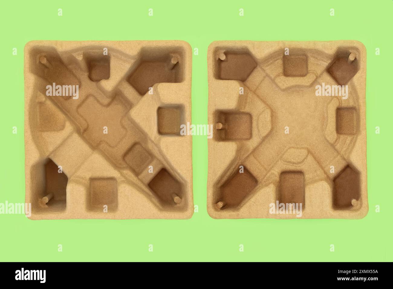 Cardboard delivery box inserts on green background. Biodegradable eco ...