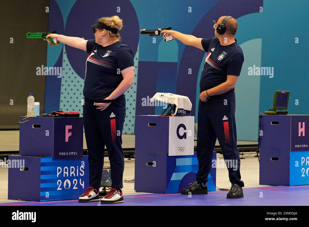 Serbia's Zorana Arunovic, left, and Damir Mikec compete in the 10m air pistol mixed team gold ...