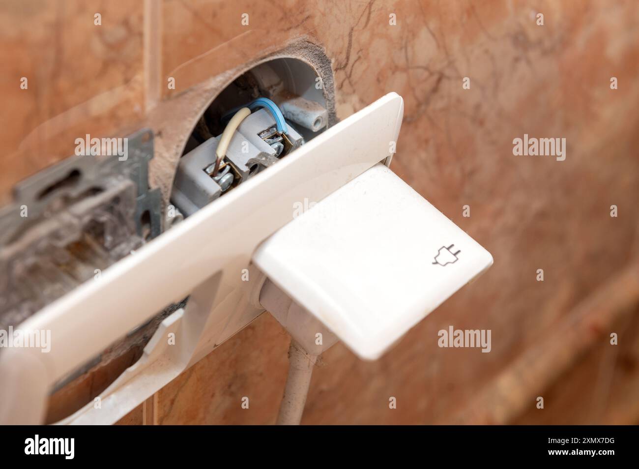 Broken socket on ceramic tile wall. Broken outlet. Concept of risk of ...