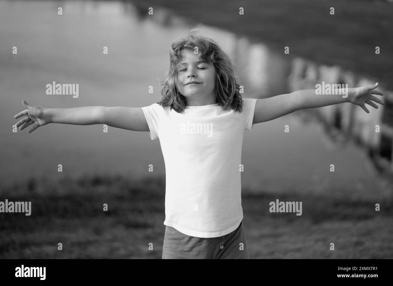 Kid with arms up enjoying freedom in nature. Child open arms enjoying ...