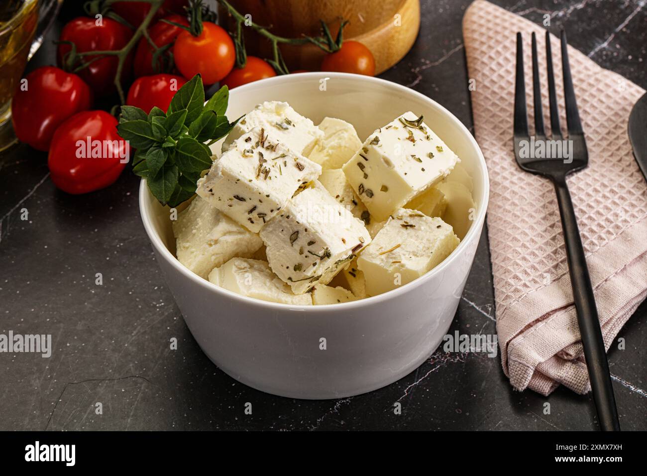 Greek traditional Feta cheese cubes with herbs and spices Stock Photo ...