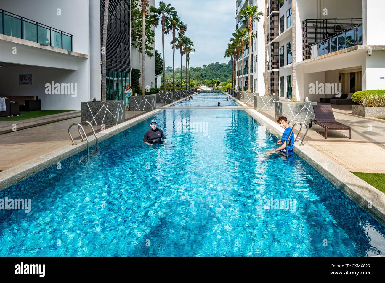People enjoy a swim in the swimming pool belonging to an apartment ...