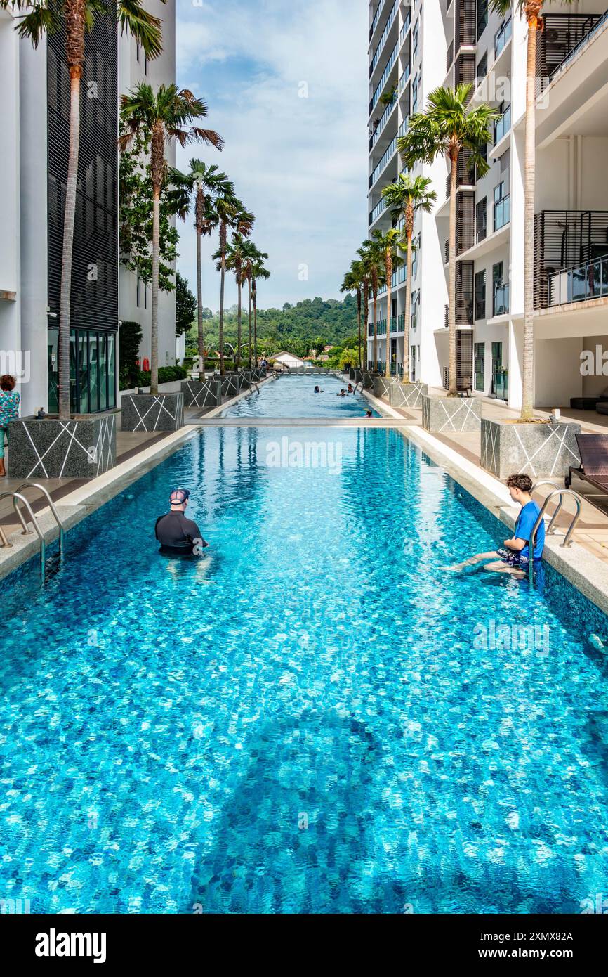 People enjoy a swim in the swimming pool belonging to an apartment ...