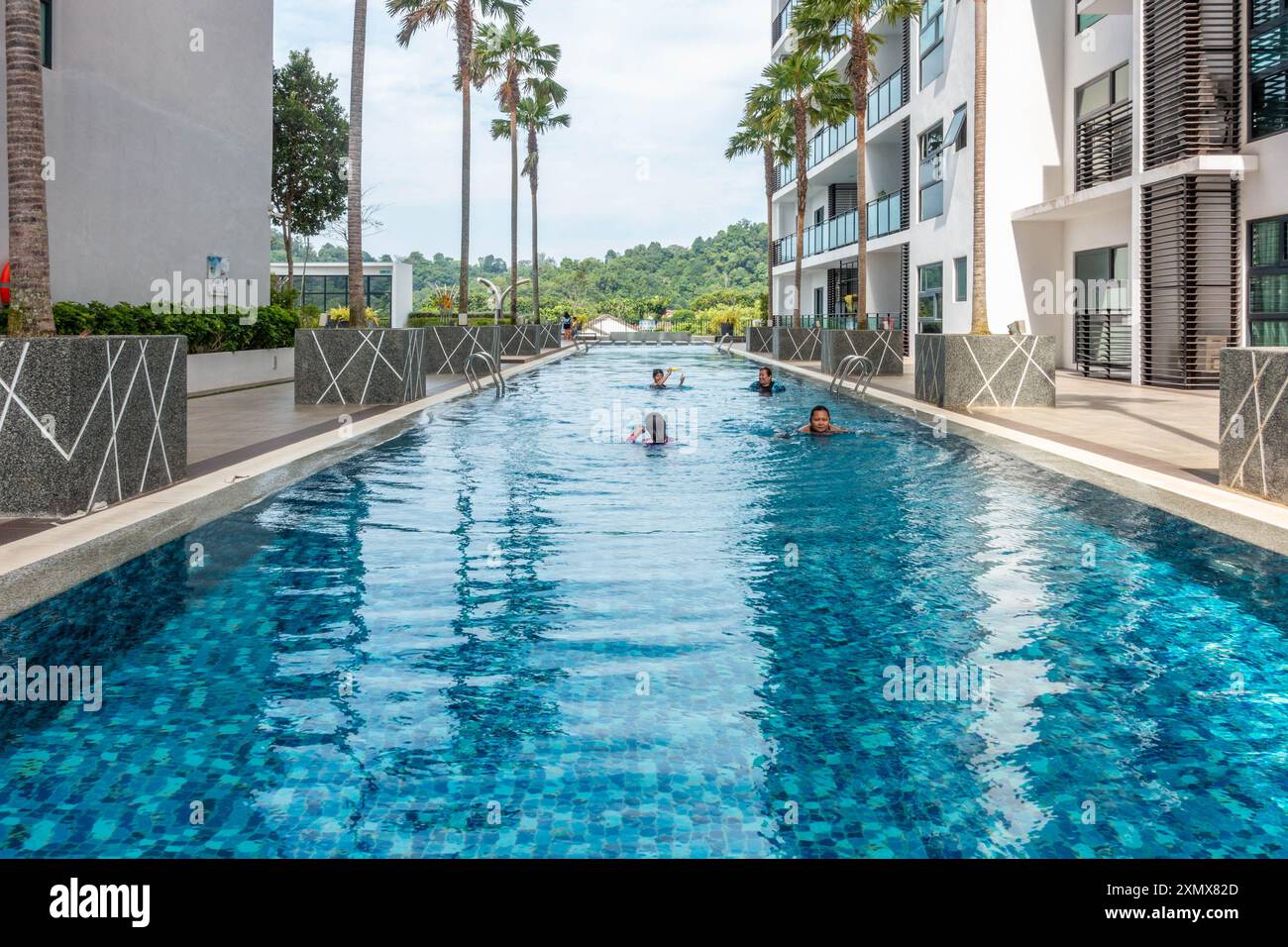 People enjoy a swim in the swimming pool belonging to an apartment ...