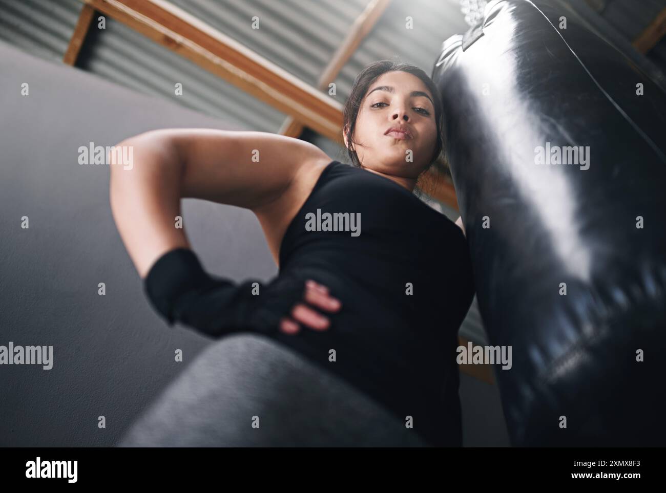 Woman, portrait and punching bag in gym for training, cardio boxing and ...