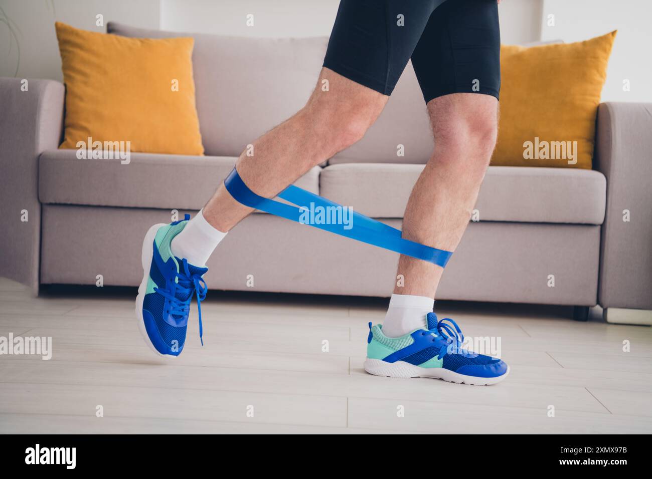 Photo of strong man doing physical exercises with rubber expander ...