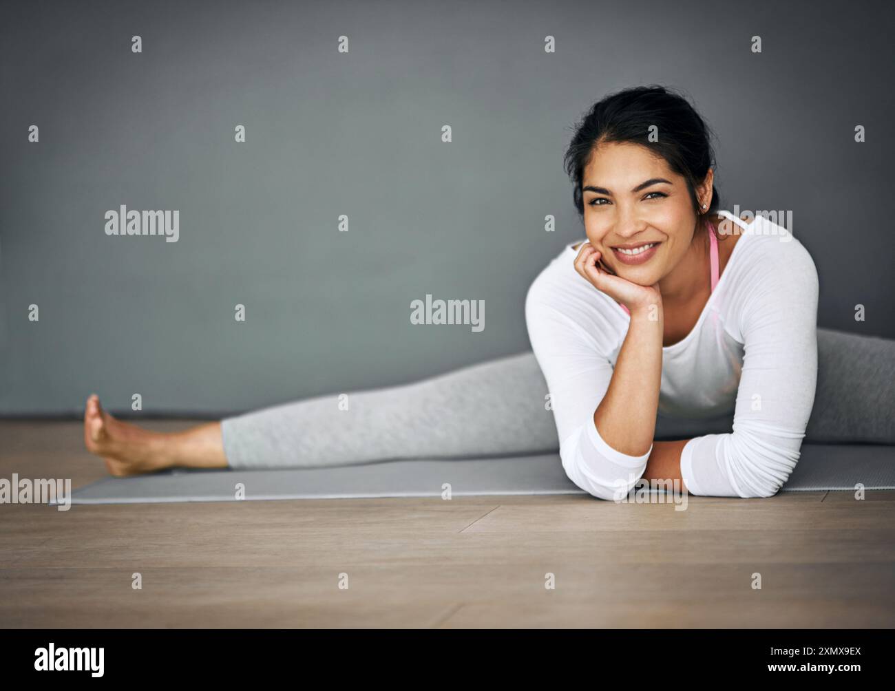 Woman, wellness and home portrait in splits, pilates and wall ...