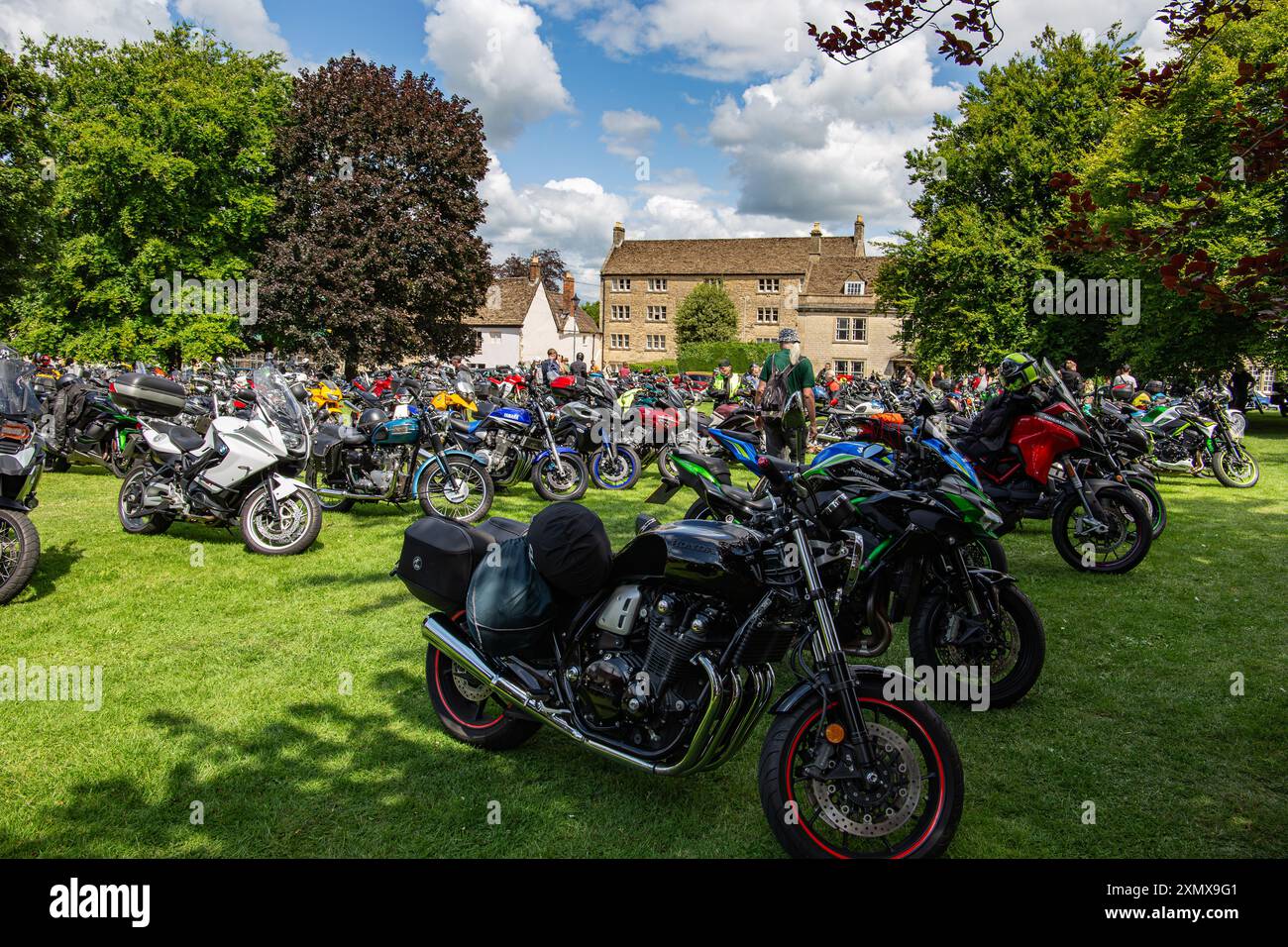 A scenic outdoor motorcycle gathering, with numerous motorcycles parked ...