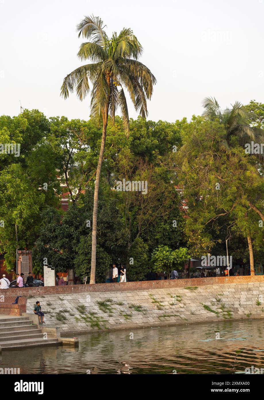 Bangladeshi people walking along a pond, Khulna Division, Jessore ...