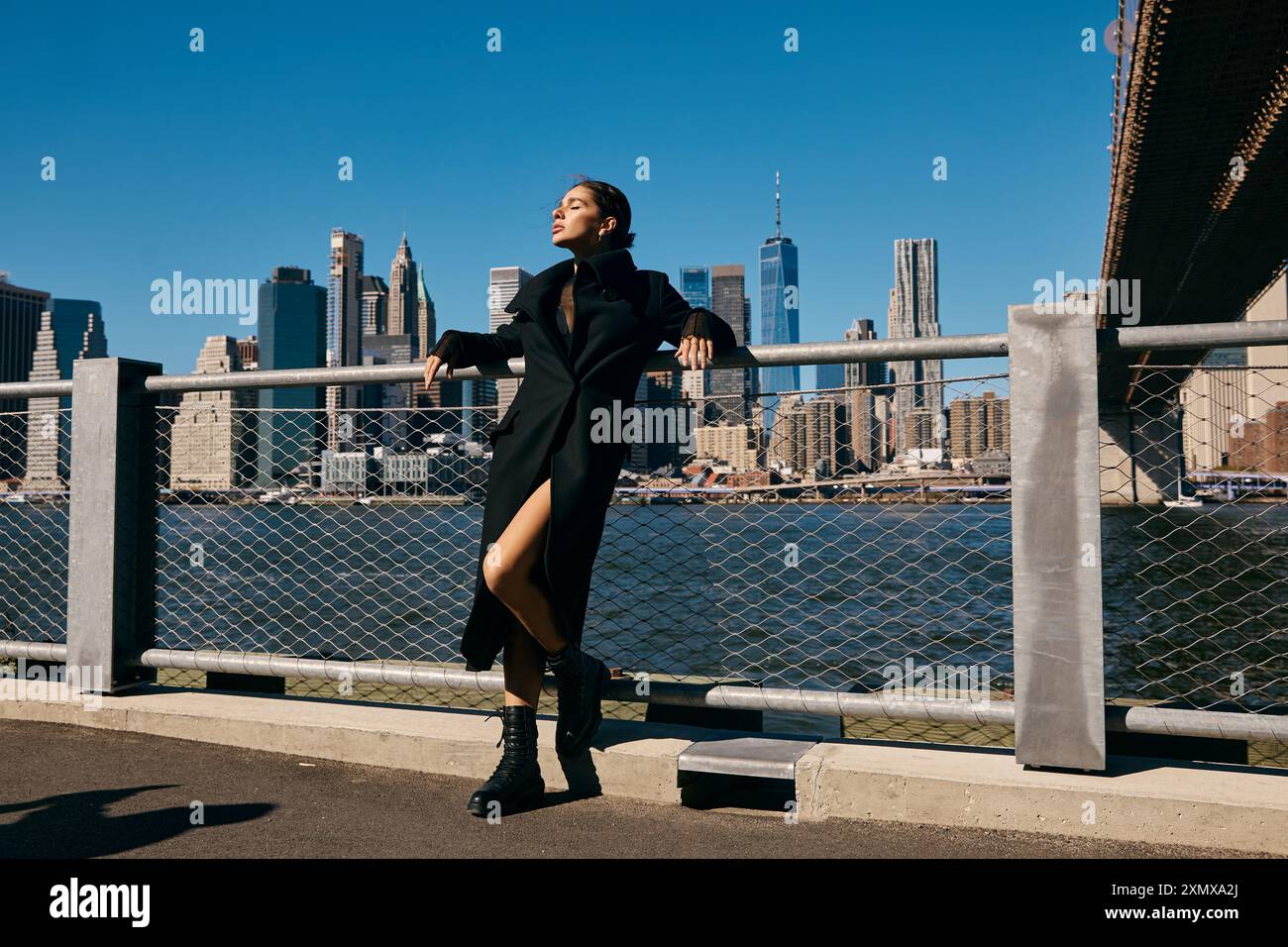 A young woman dances on a New York City street, her coat billowing in ...