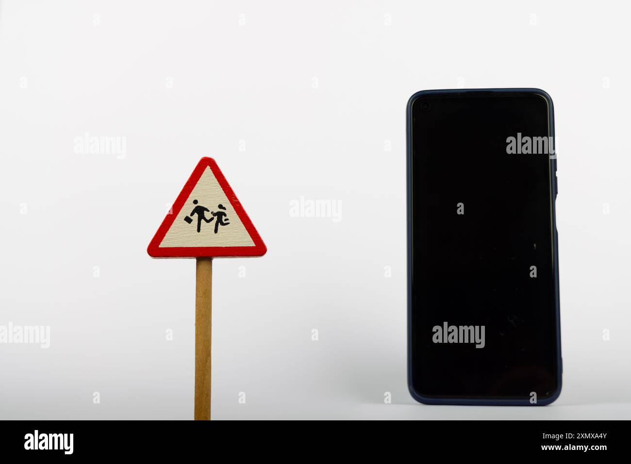 A wooden toy warning sign labeled "WARNINGS CHILDS" is placed next to a ...