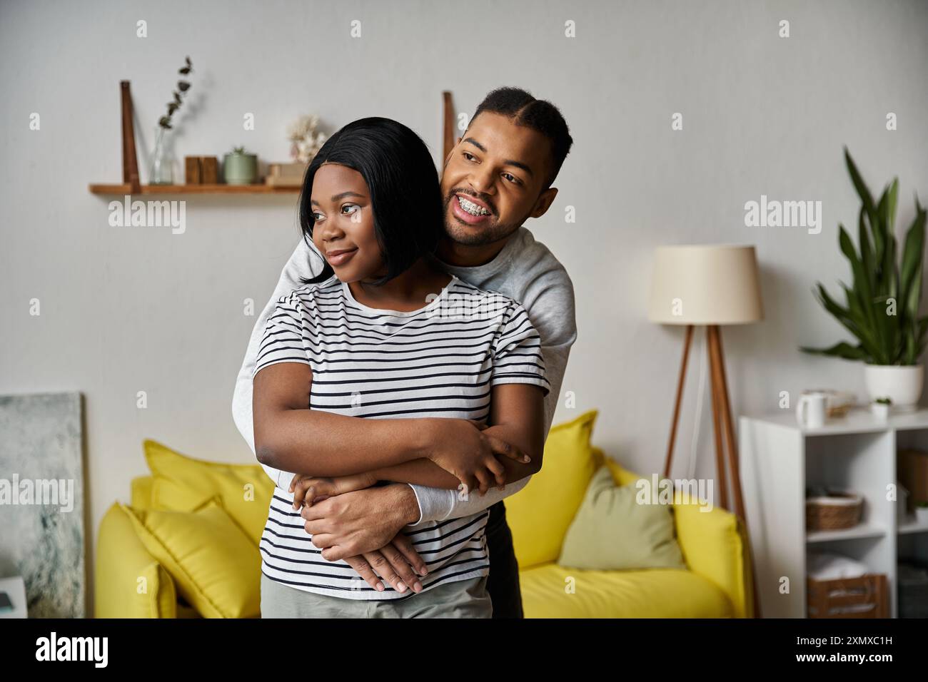 An African American couple share a loving embrace in their home Stock ...