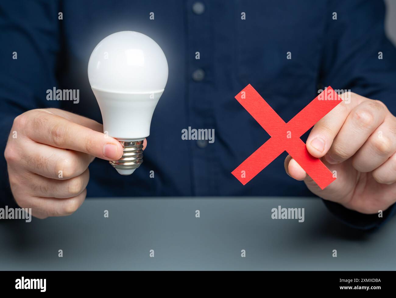 Businessman holding idea light bulb and red cross. Initiative or ...