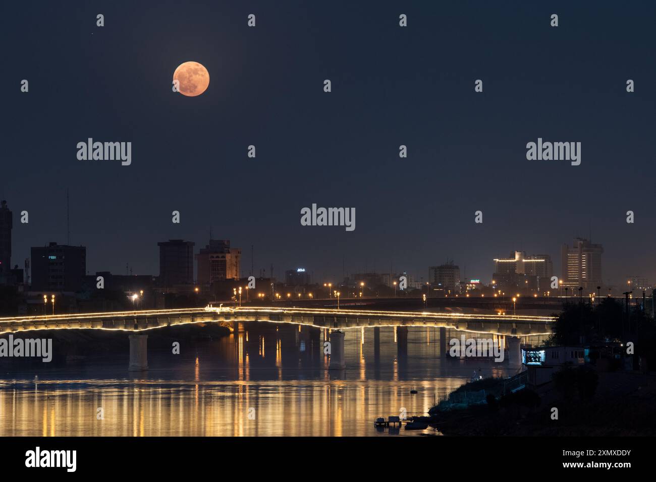 Super moon rises behind Baghdad skyline on the night of 15 June 2022 ...