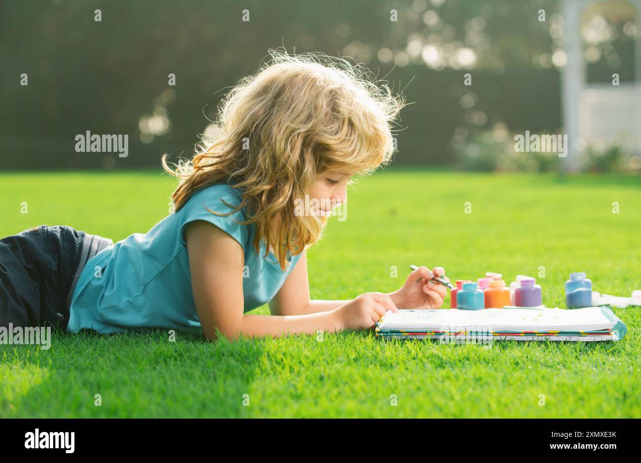 Kids drawing. Child boy drawing in summer park, painting art. Little ...