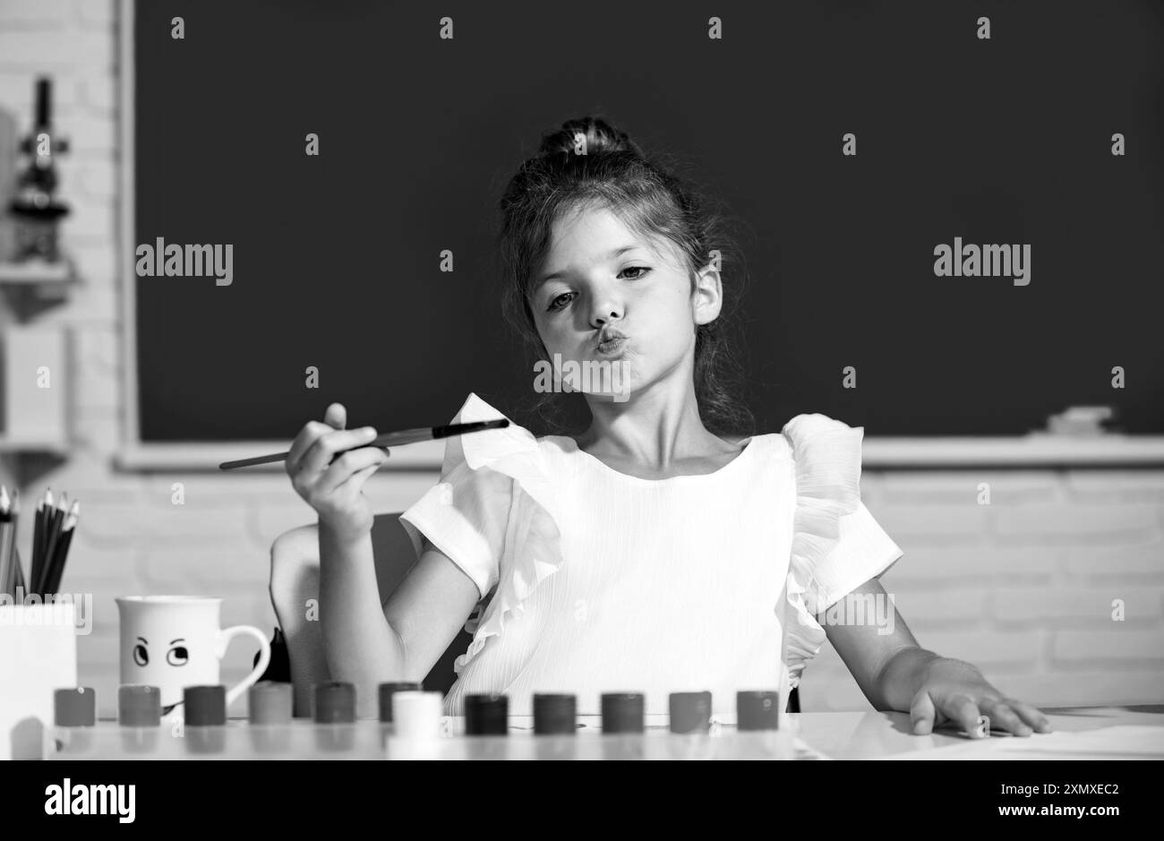 Cute little girl child painting with paints color and brush. Little ...