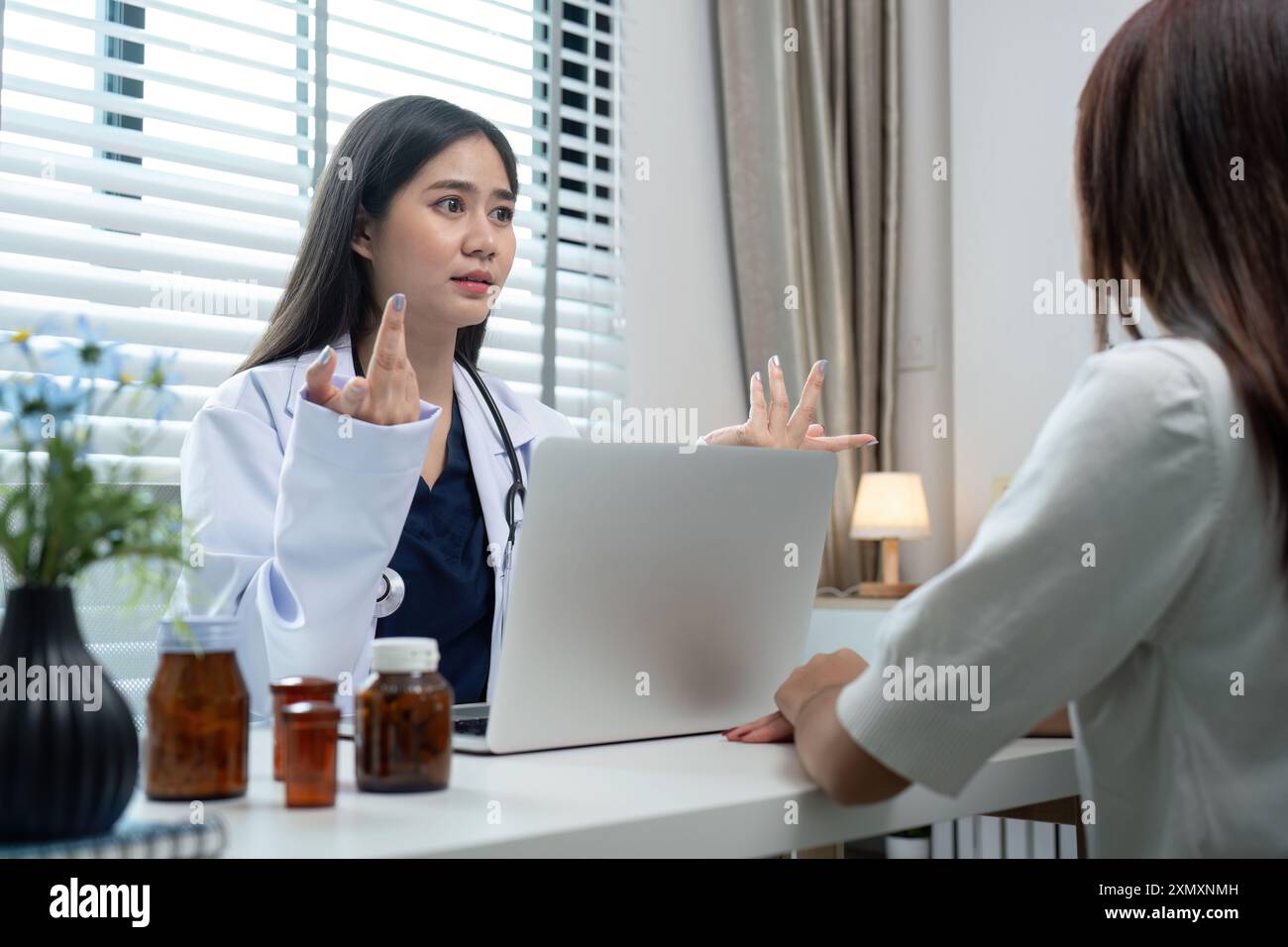 Female Doctor Consulting with Patient in Modern Medical Office ...