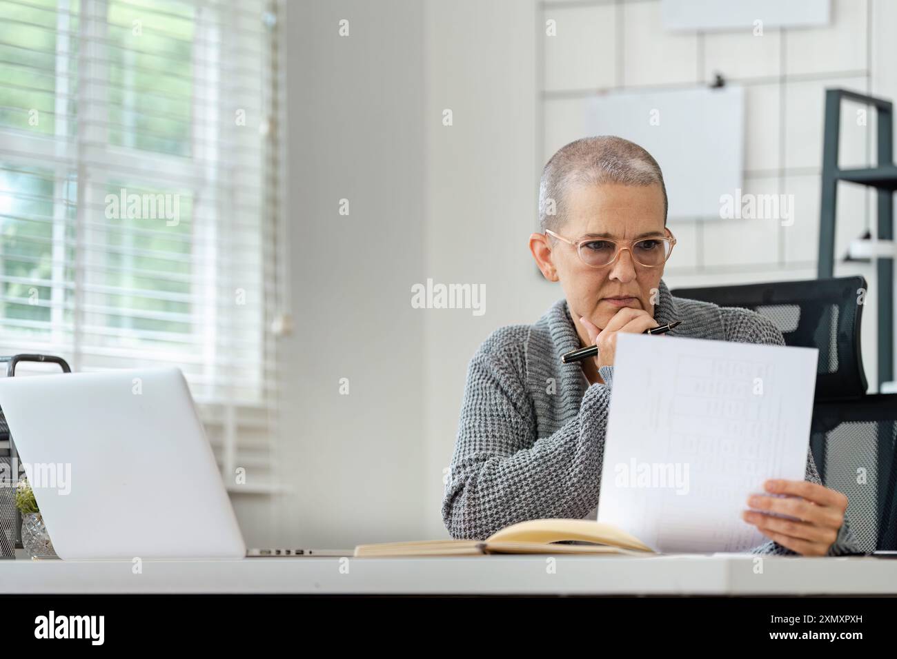 Senior Woman Reviewing Financial Documents at Home for Saving and ...
