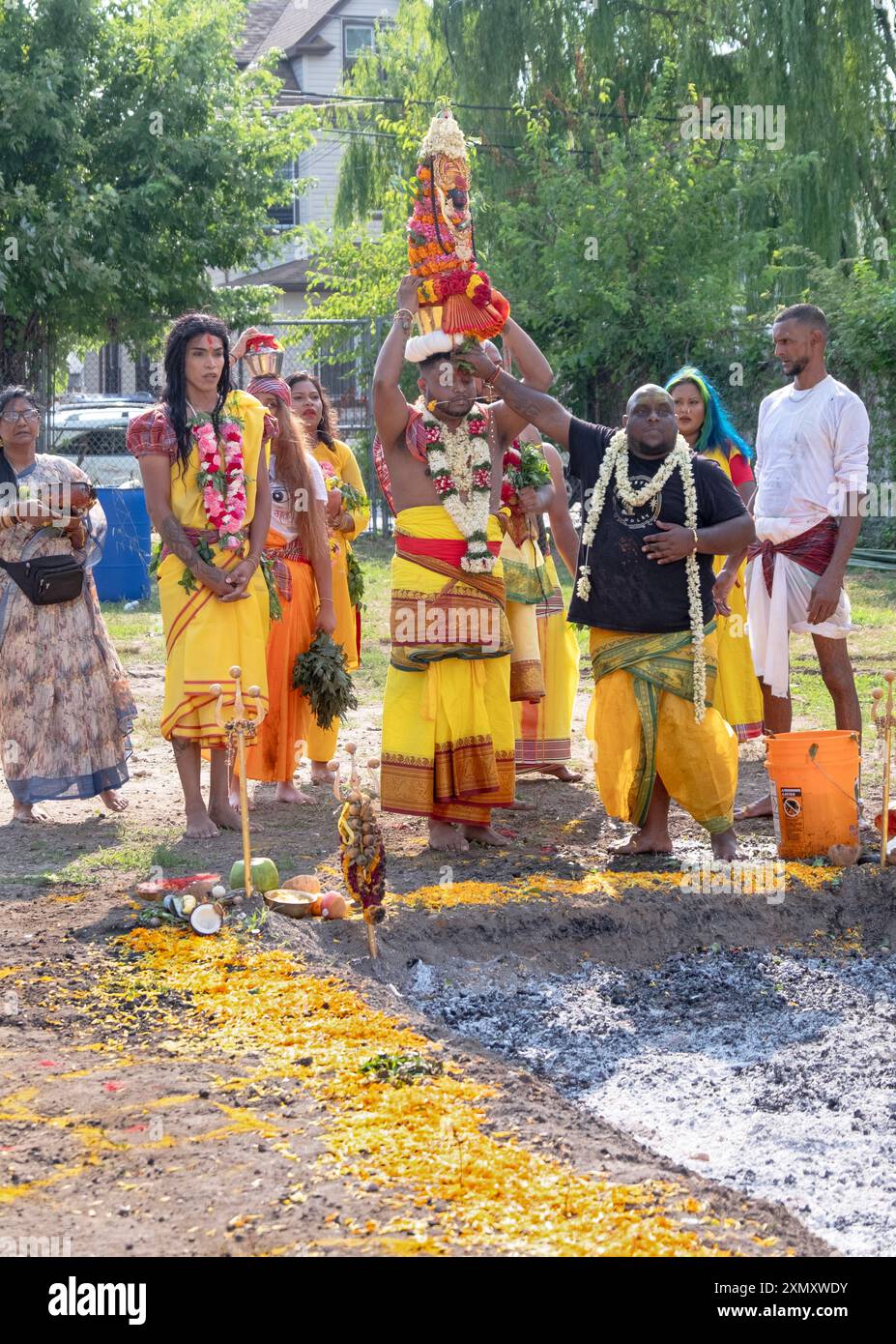 A cleansing prior to walking over hot coals with a statue of Kali ...
