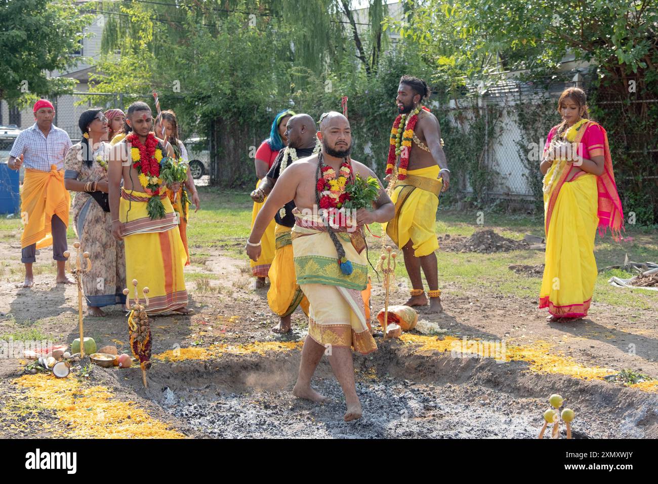 A Devout Hindu man wearing a garland necklace walks barefoot on hot ...