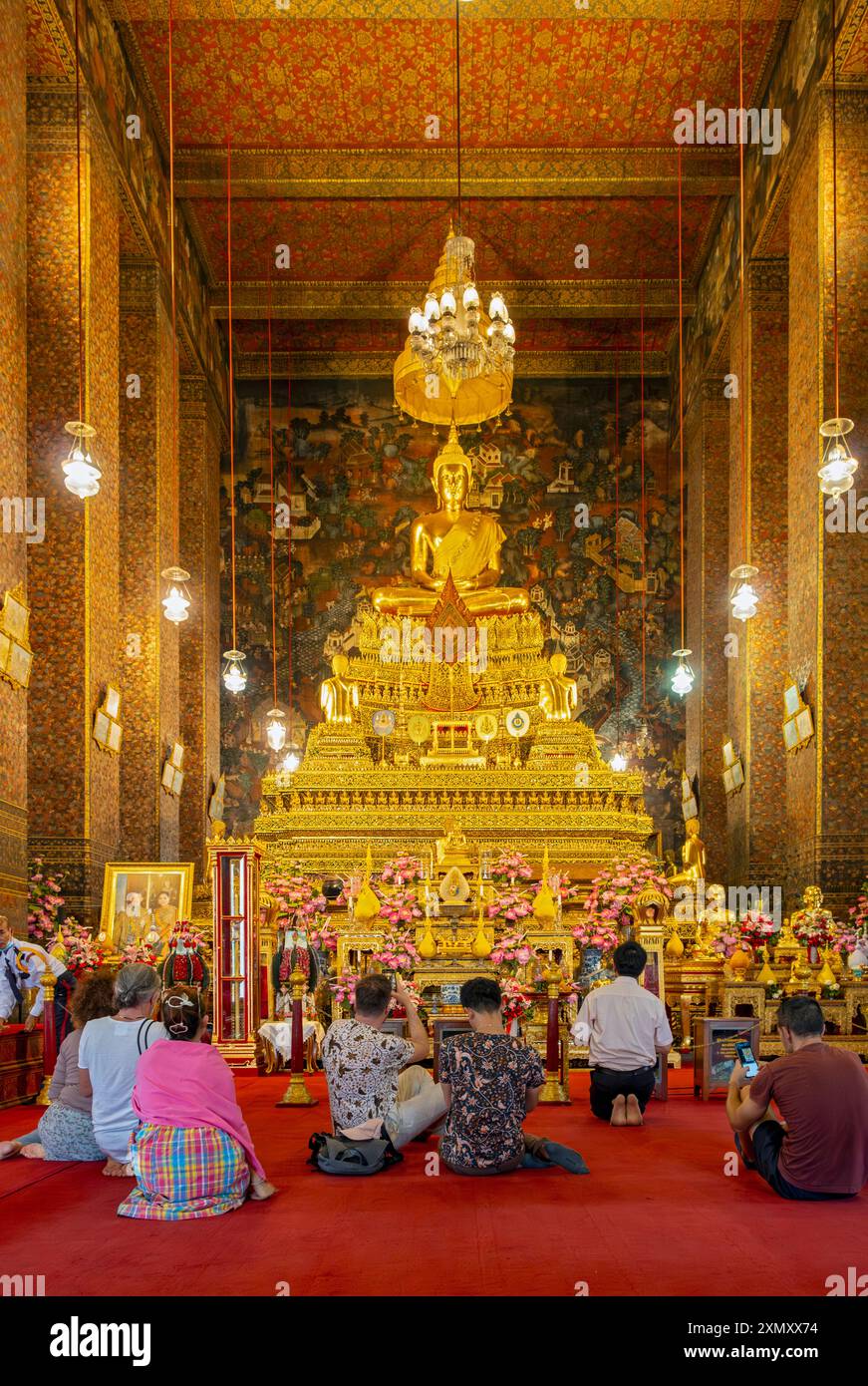 Worshippers oin front of Phra Buddha statue at the Phra Ubosot ...