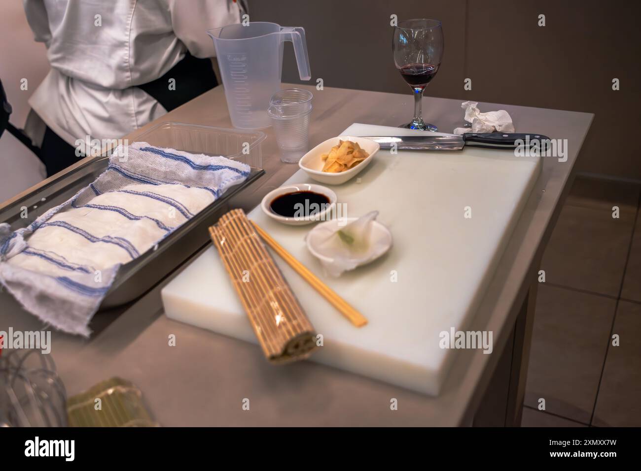 A well-organized sushi workshop table, fully prepared with ingredients ...