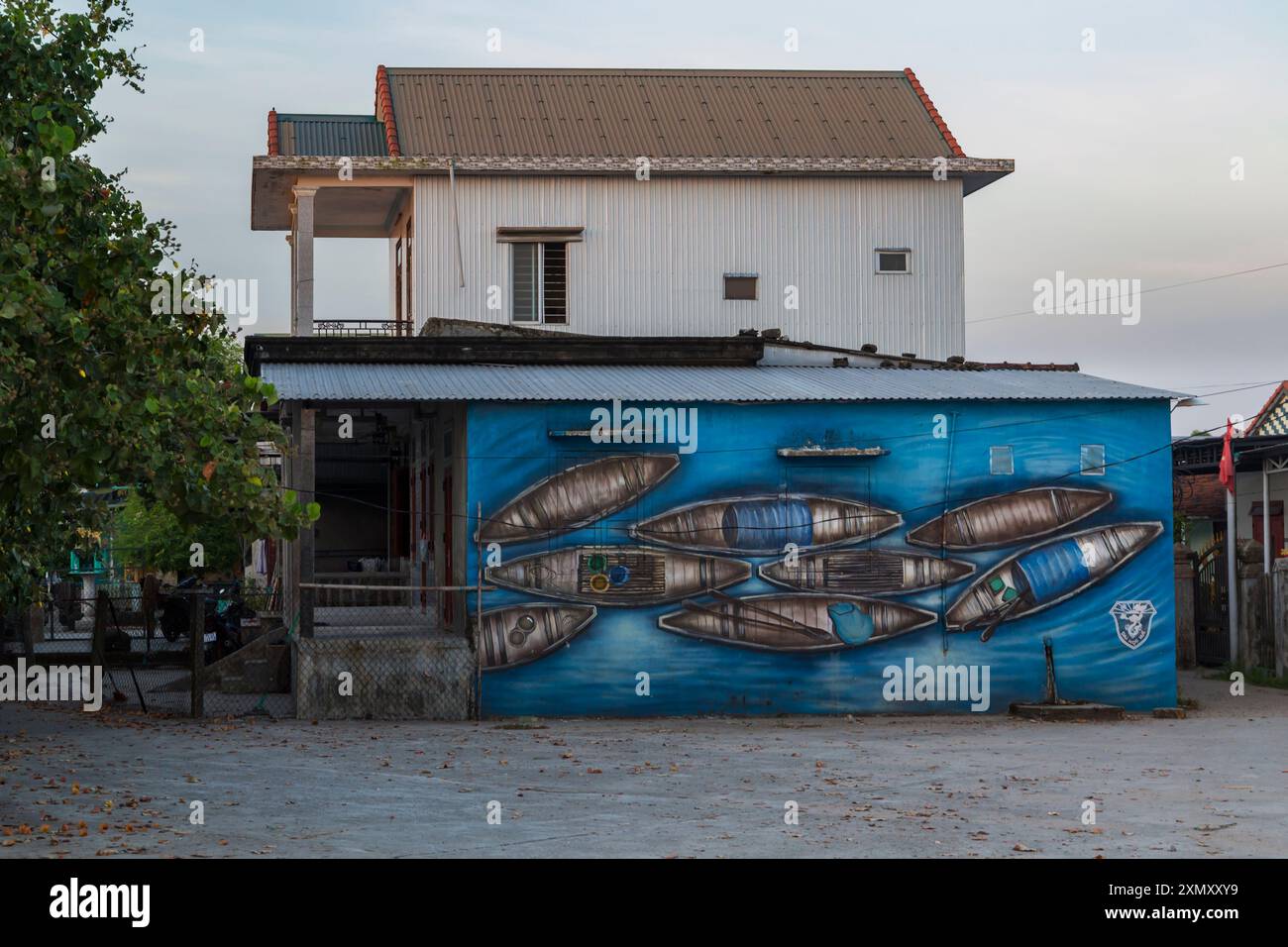Vietnamese fishing boats mural on side of building by Quang Loi Lagoon ...